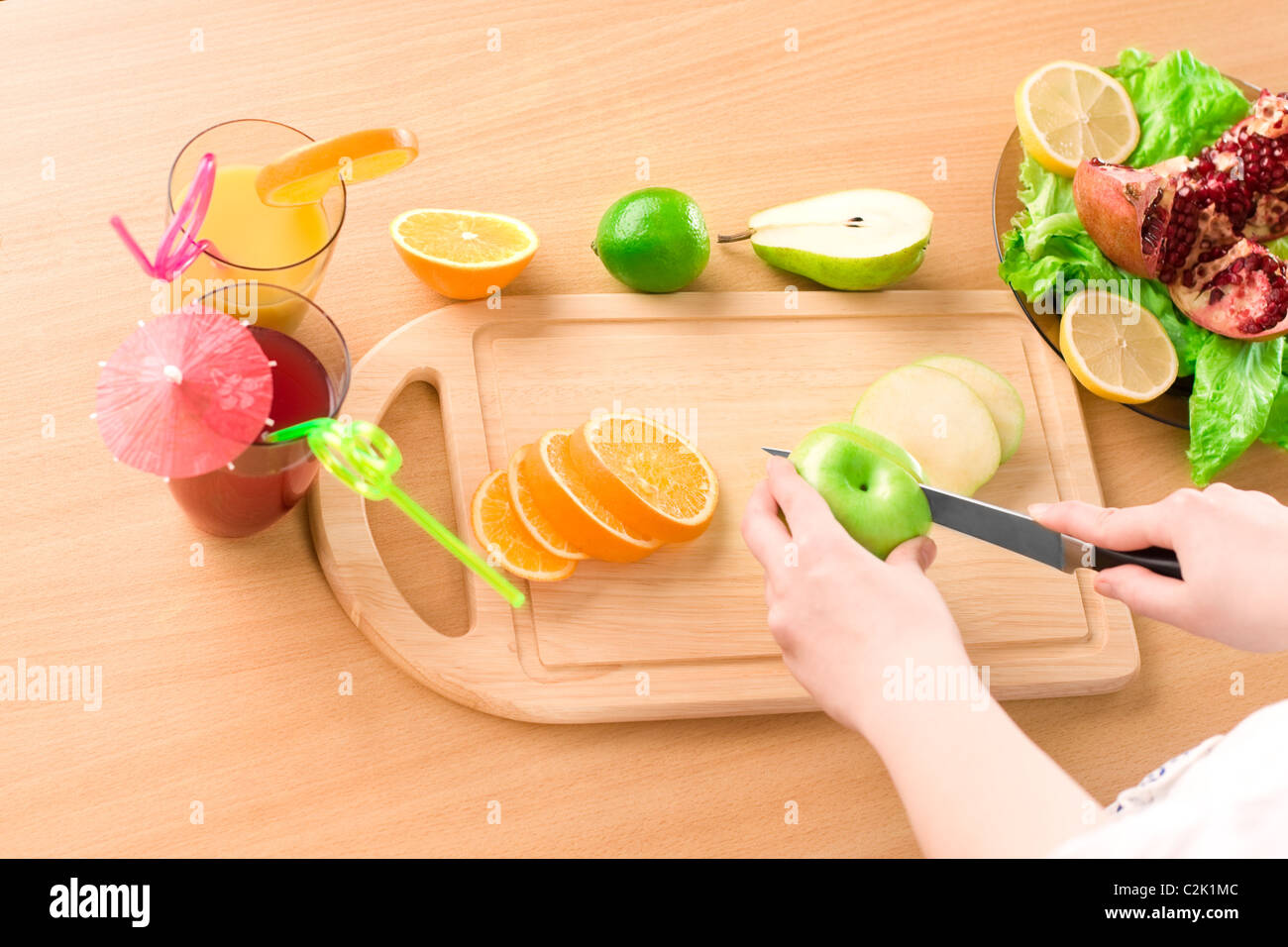 Woman's hands with knife cutting apple Stock Photo - Alamy