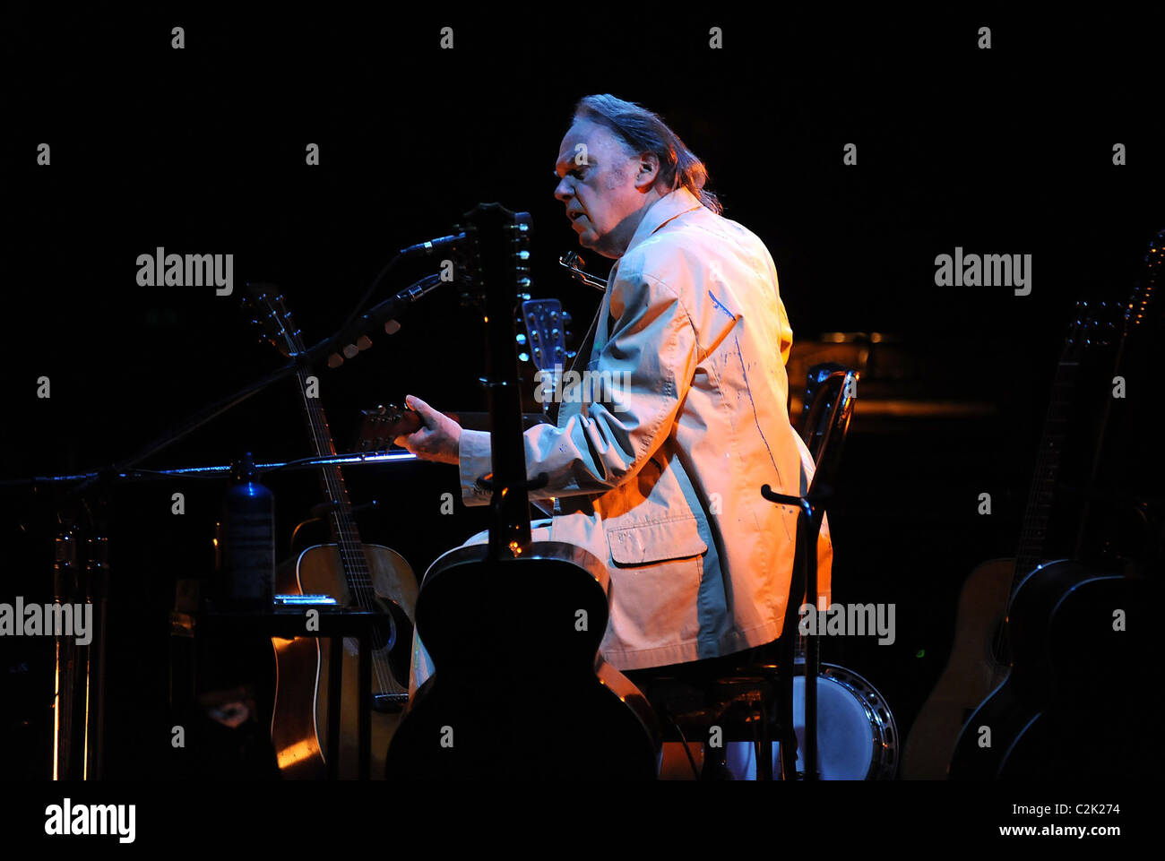 Neil Young performing live in concert at the Hammersmith Apollo London ...