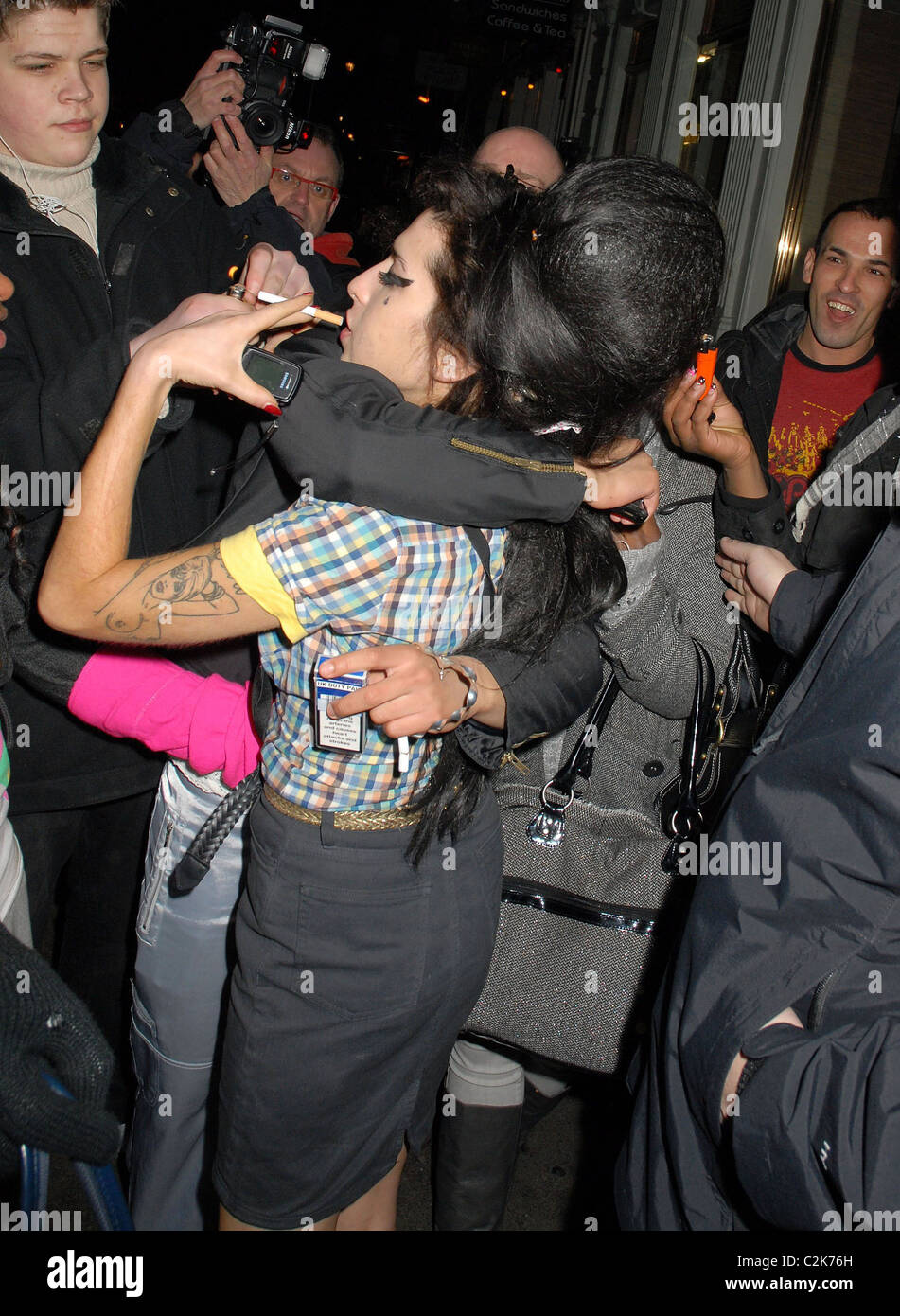 Amy Winehouse smoking a cigarette while leaving Jazz After Dark London ...