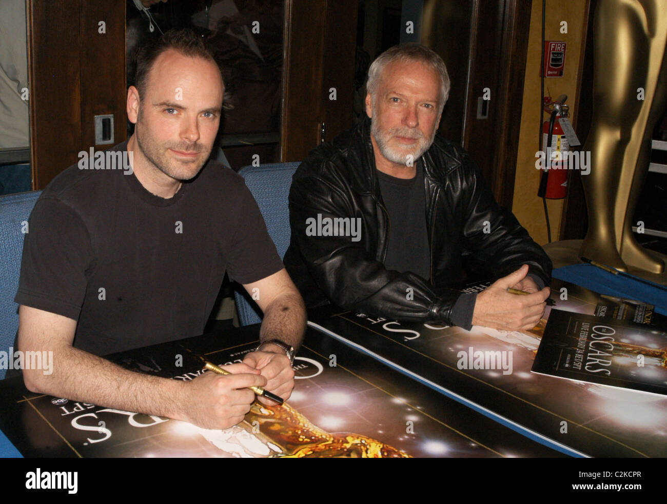 Drew Struzan and Christian Struzan sign the Oscar poster they designed ...