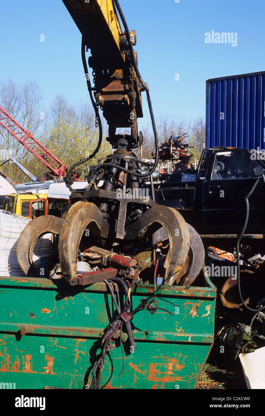 hydraulic crane grabbing scrap metal for recycling at scrapyard uk ...