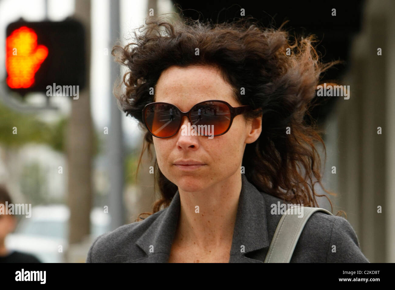 Minnie Driver holding a garment bag from 'Feraud' Beverly Hills ...