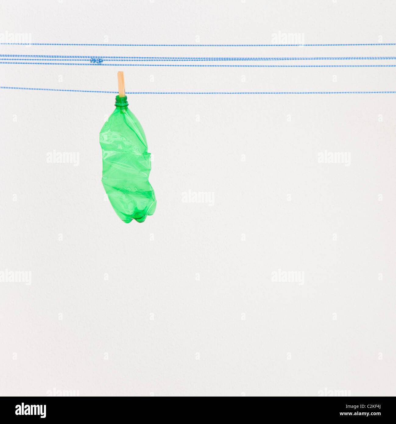 Green plastic objects hanging on a washing line Stock Photo - Alamy
