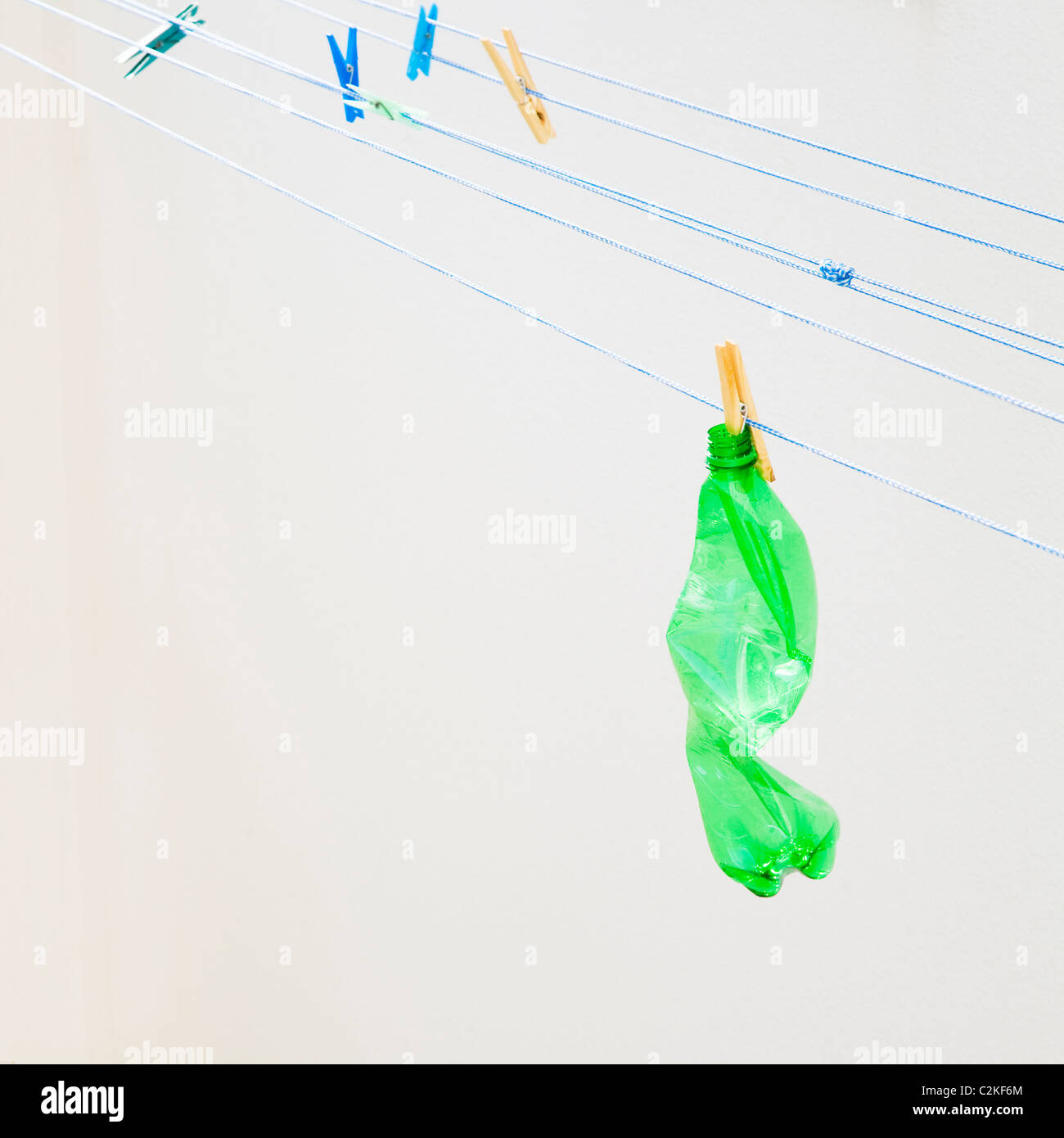 Green plastic objects hanging on a washing line Stock Photo - Alamy