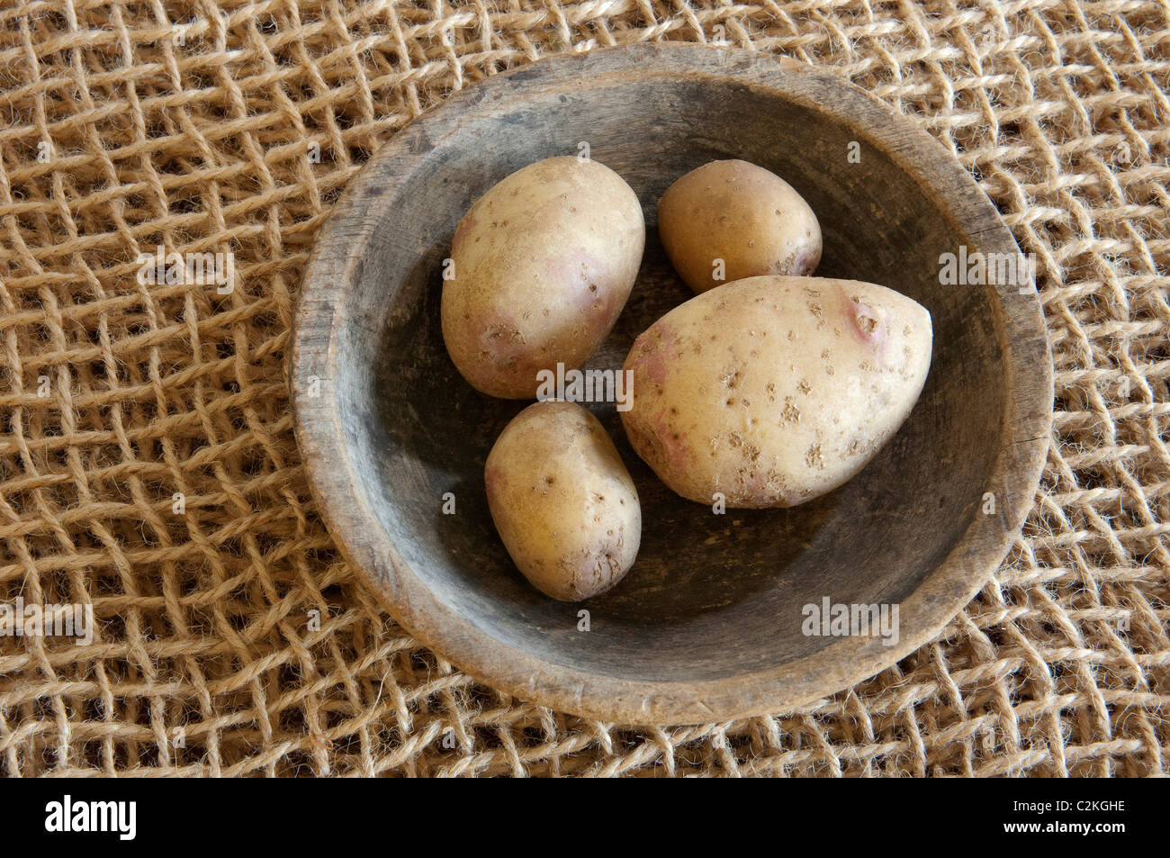 King Edward potato (Solanum tuberosum King Edward). Potatoes a wooden ...