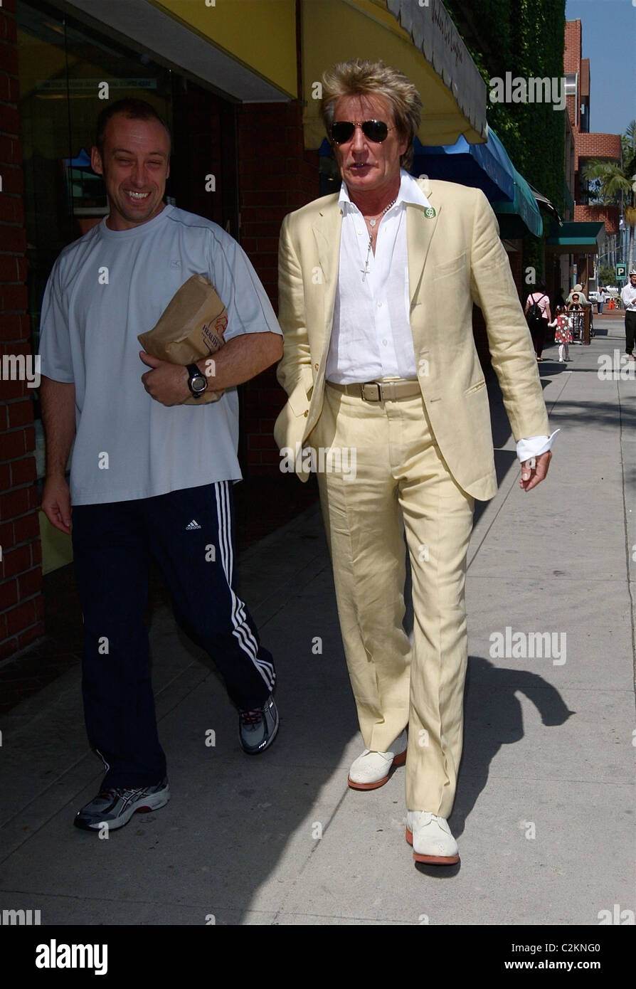 Rod Stewart leaves a medical building with his assistant who carries ...