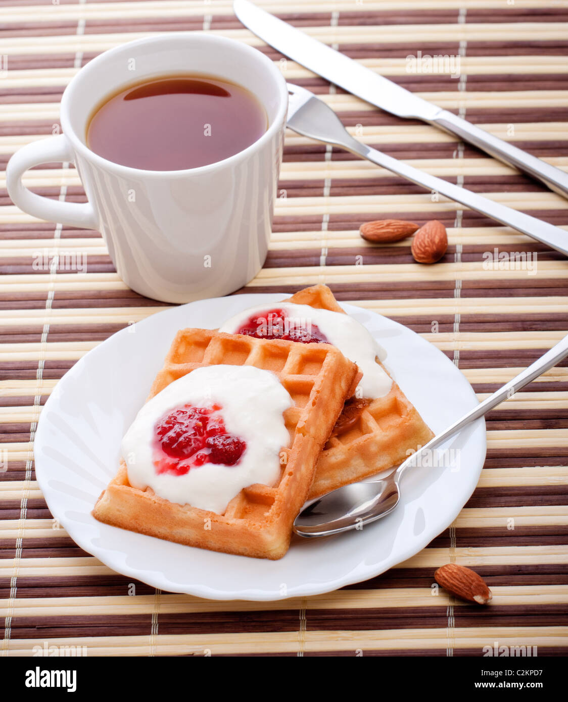 dessert with soft waffle, tea and raspberry jam Stock Photo - Alamy
