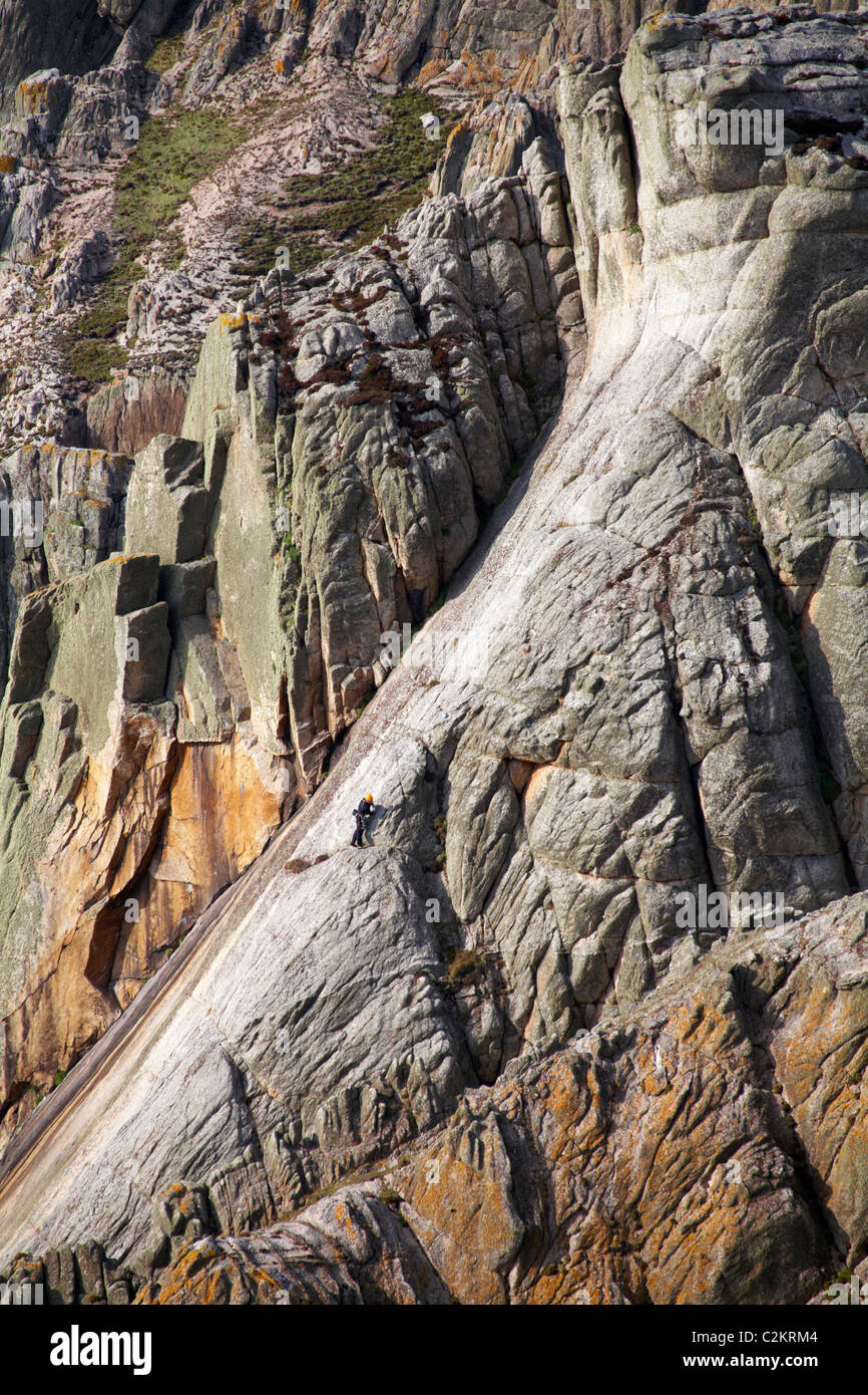 Climber climbing up Devils Slide on Lundy Island, Devon, England UK in ...
