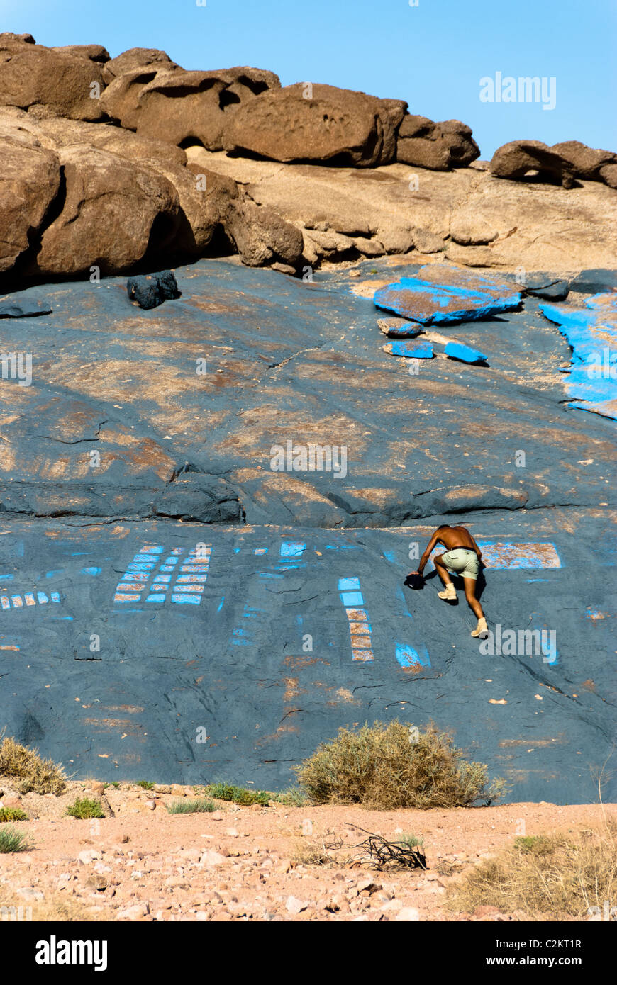 Man climbing rocks in the blue desert - Sinai Peninsula, Egypt Stock ...