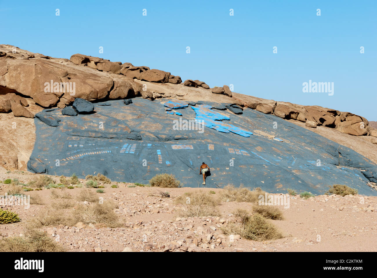 Man climbing on rocks in the blue desert - Sinai Peninsula, Egypt Stock ...