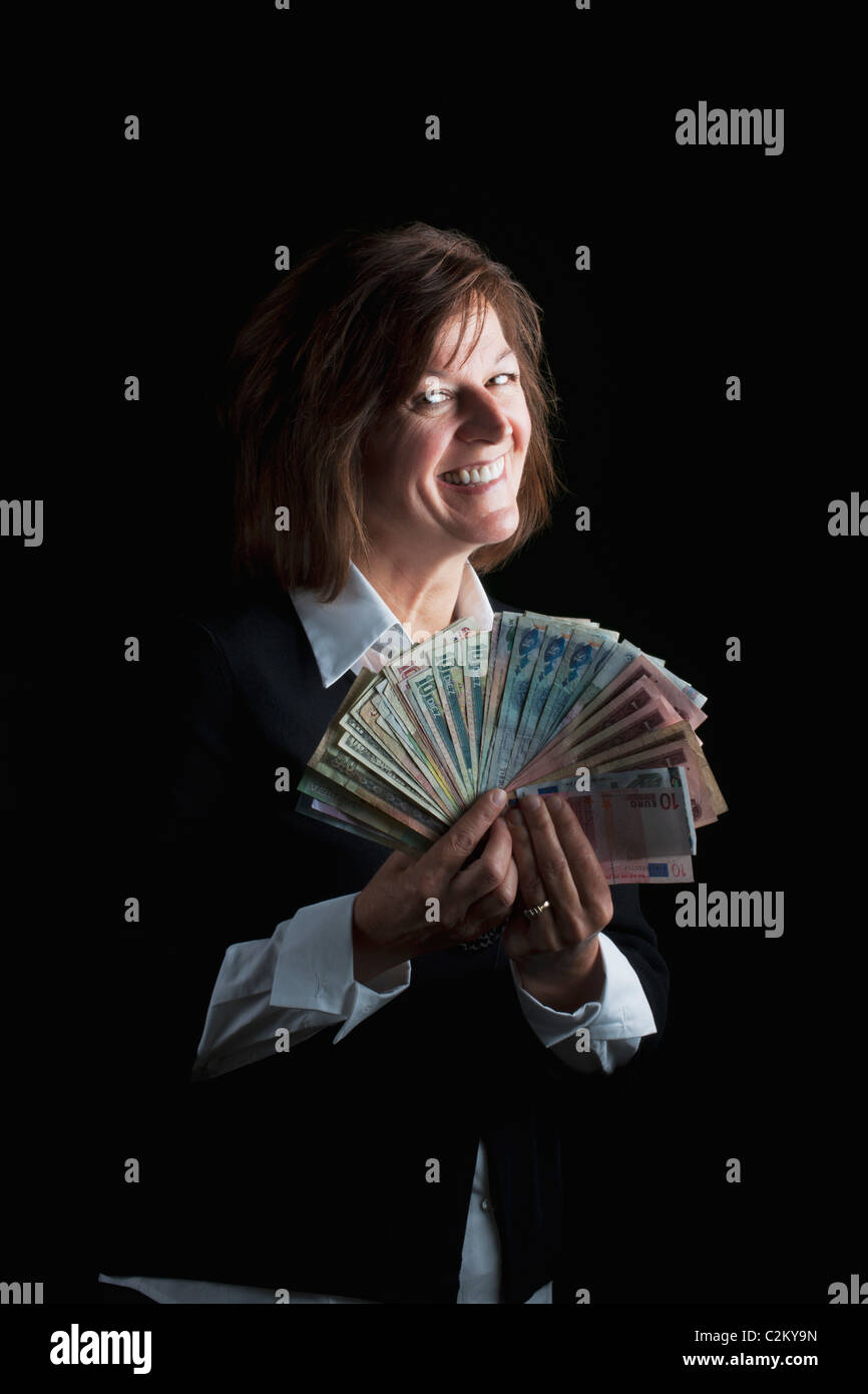 Mature woman fanning money hi-res stock photography and images - Alamy