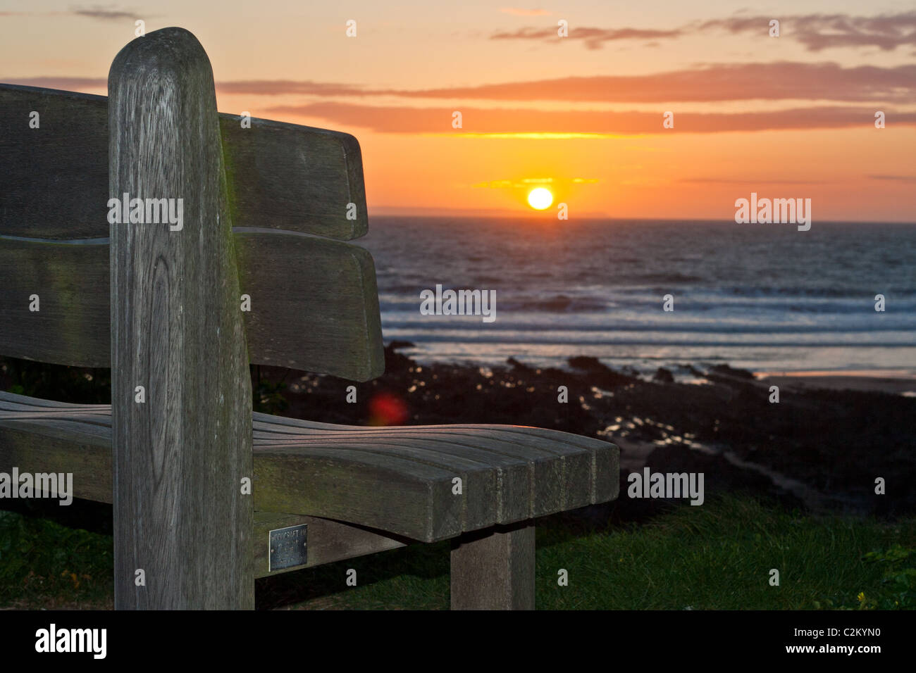Sunset over beach Stock Photo - Alamy