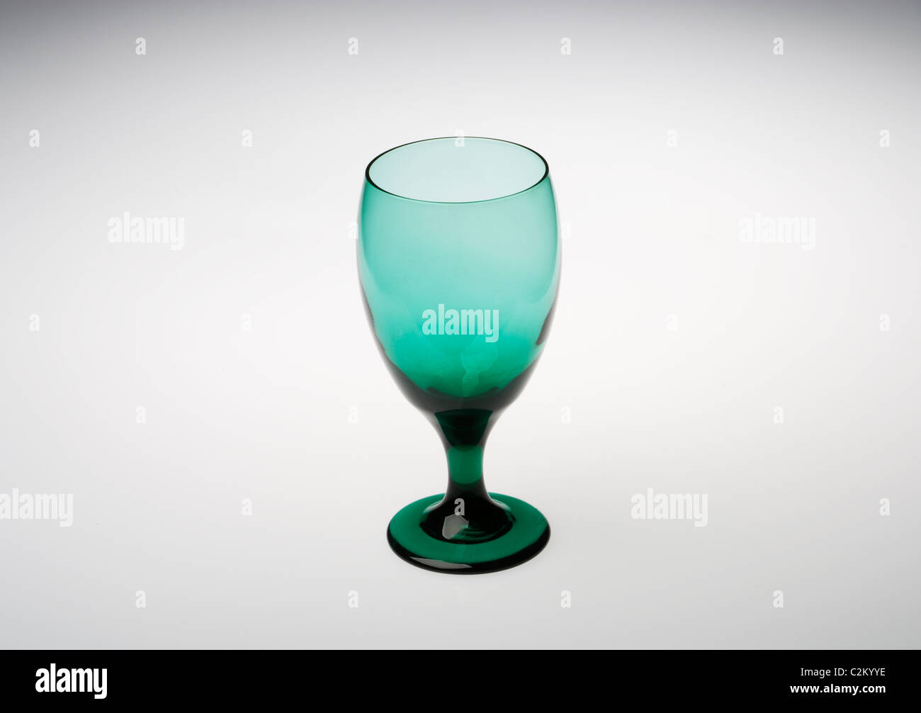 greeny blue drinking glass on a grey background Stock Photo - Alamy