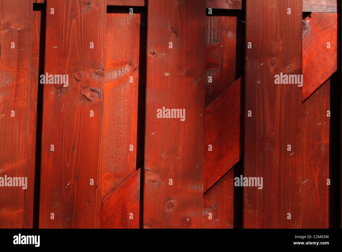 Backgrounds - detail of red stained elaborate timber fence panel Stock ...