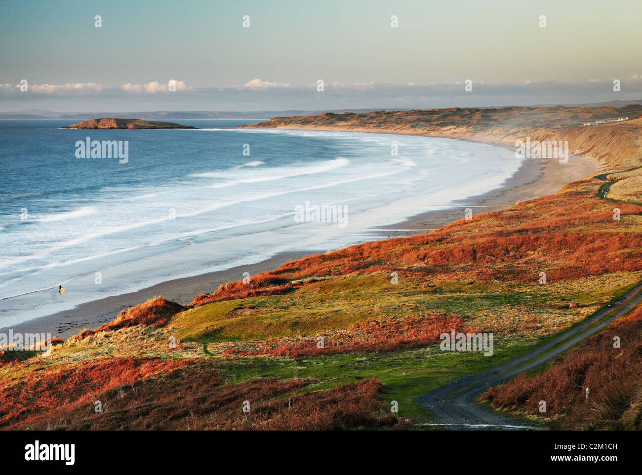 Surfer at Llangennith and Burry Holms, Rhossili Bay, Gower, Wales Stock ...