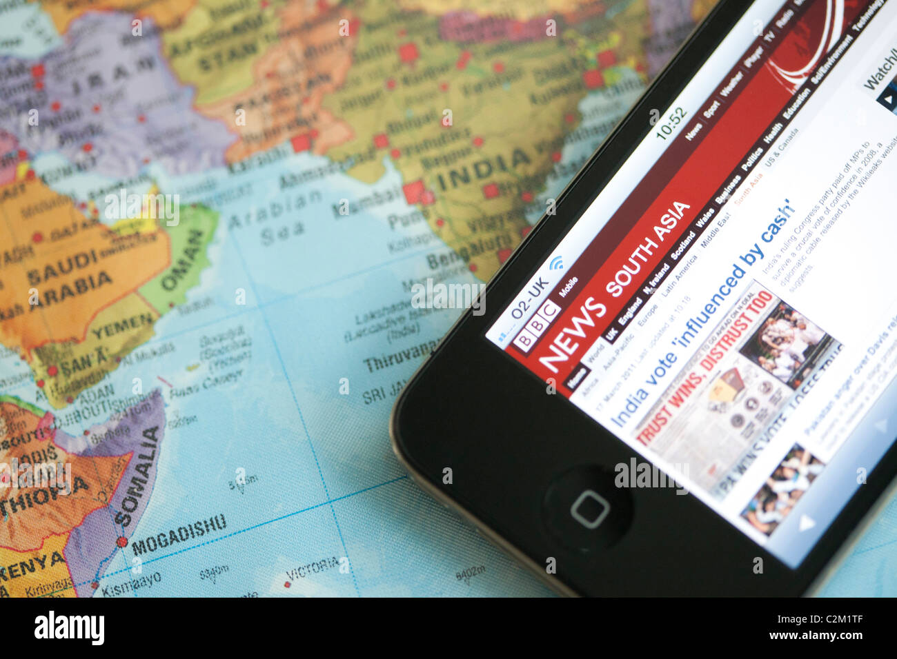 apple iphone lying on map of the world Stock Photo - Alamy