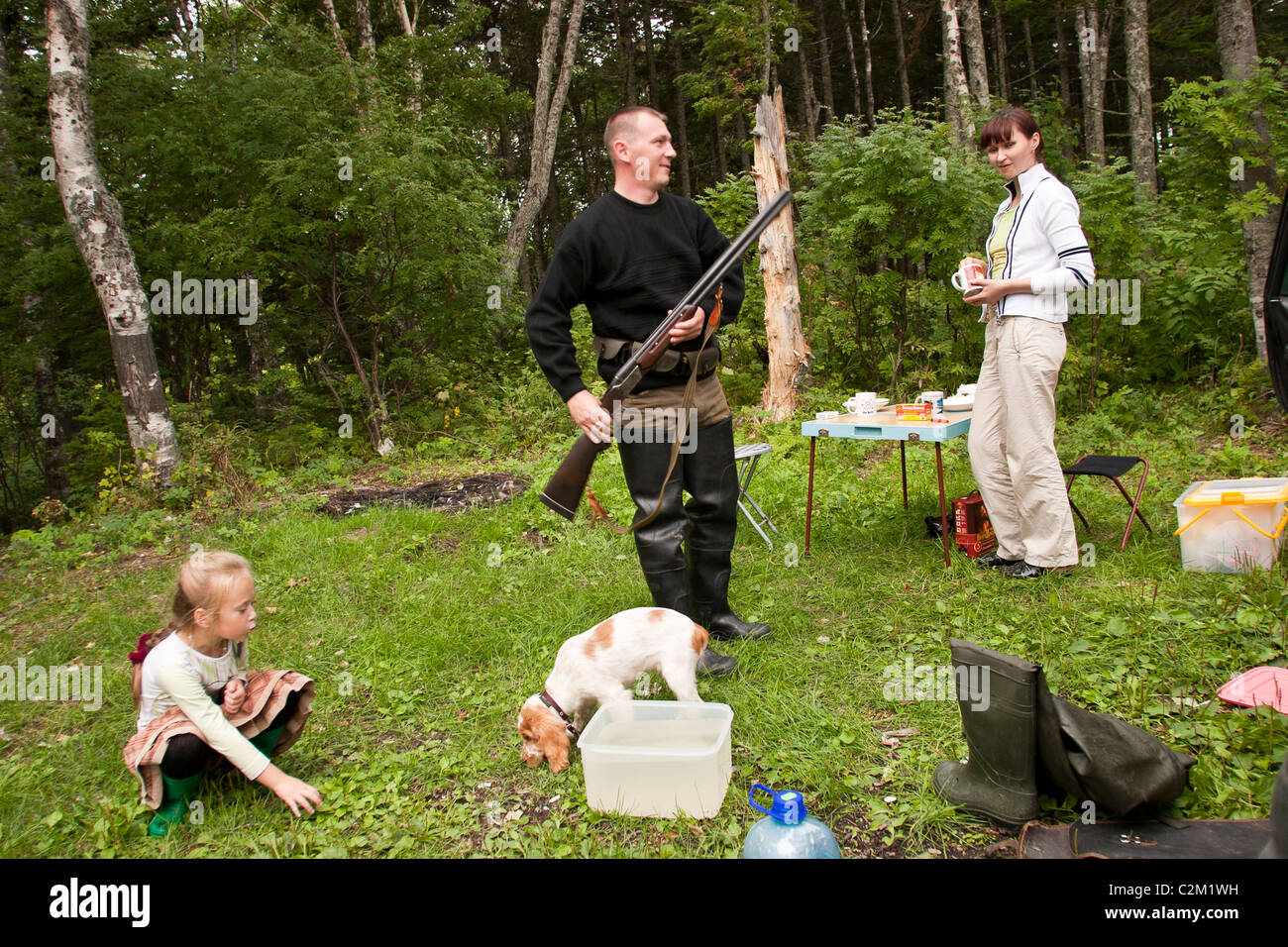 A hunter and his family setting up camp in duck hunting season outside ...