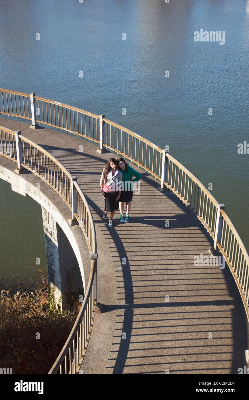 Two Teenage Girls On A Pedestrian Bridge Over A River Stock Photo - Alamy
