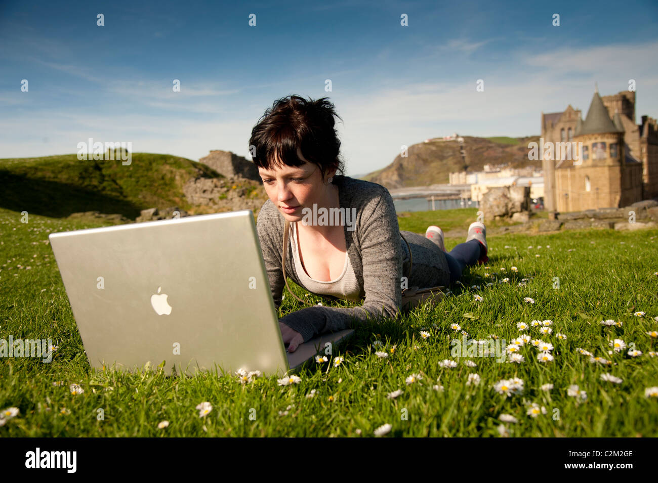 A young woman UK Aberystwyth university student working on her apple ...