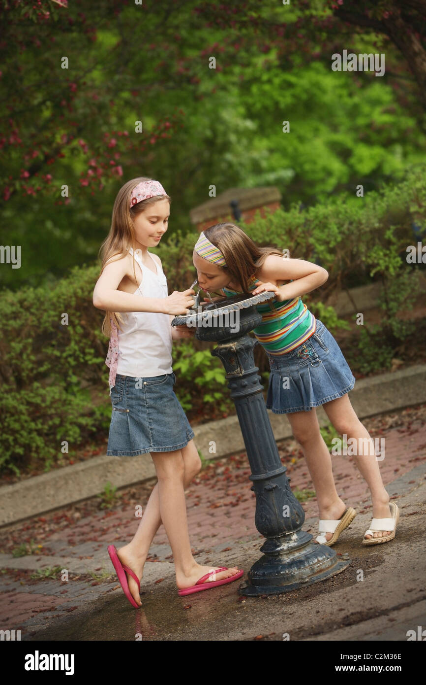 Edmonton, Alberta, Canada; Two Girls At A Drinking Fountain Stock Photo ...