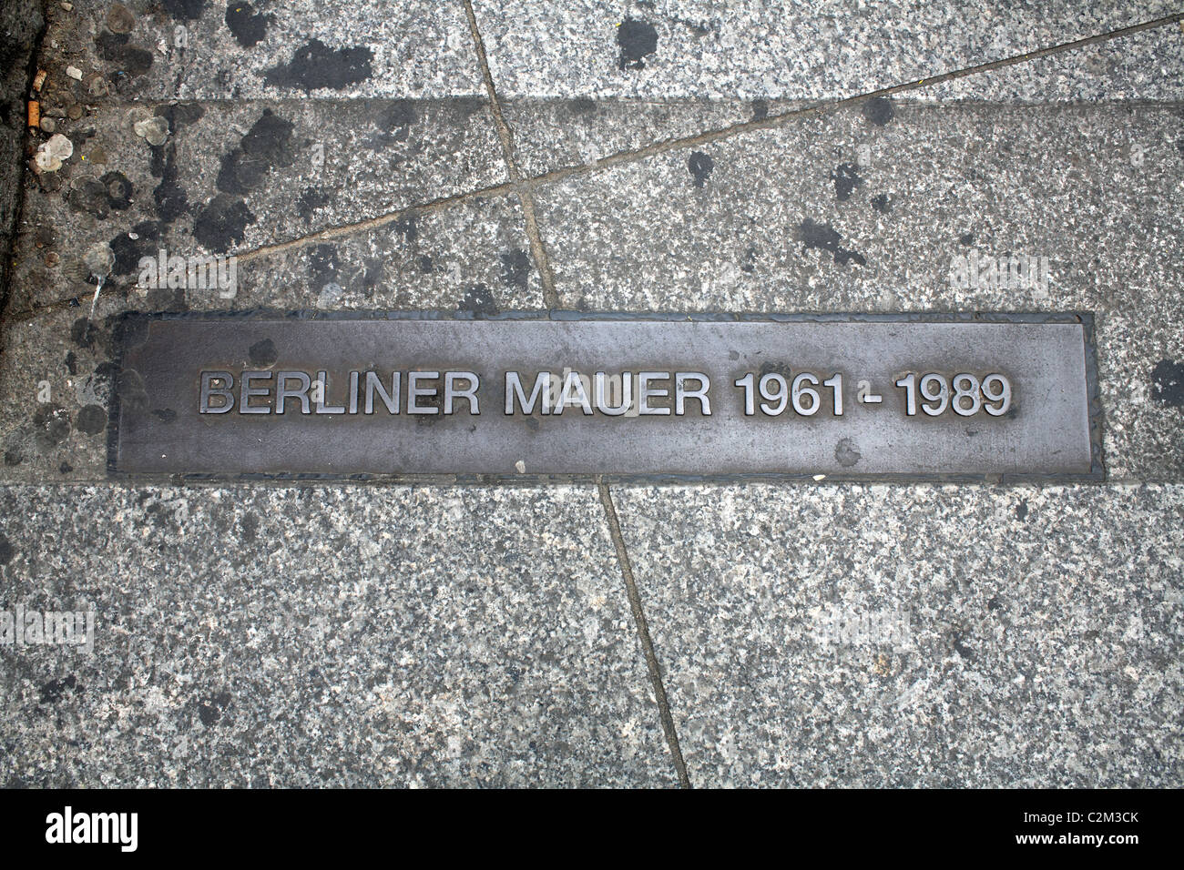 A plaque commemorating the former location of the Berlin Wall at the ...