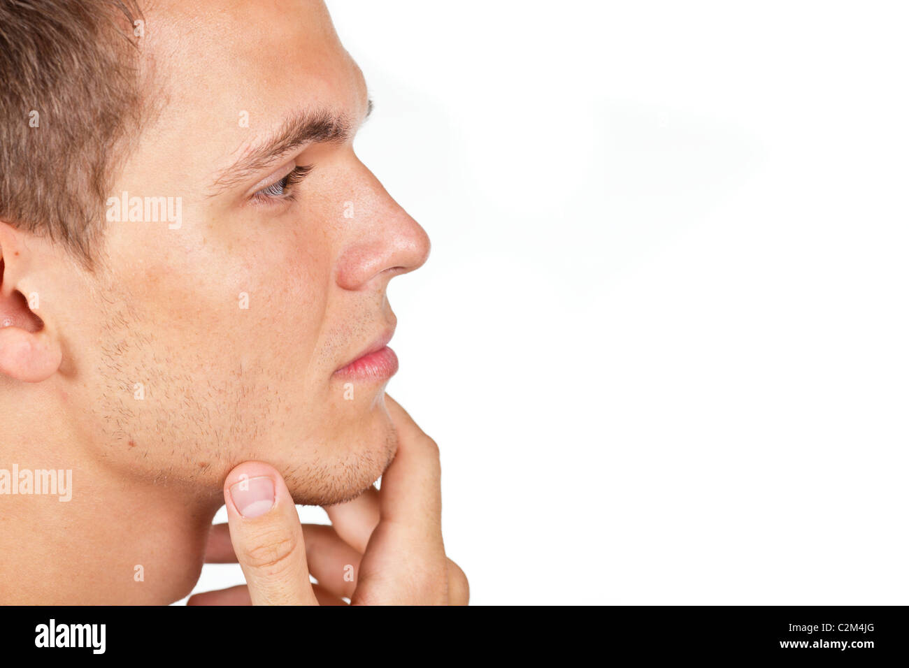 Closeup portrait of a thoughtful young man with hand on his chin Stock ...