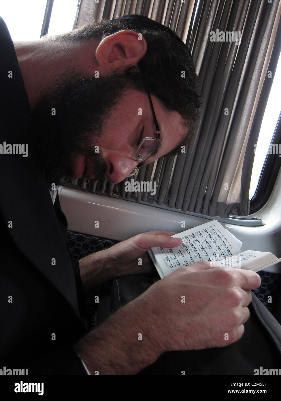 A Haredi Jew sleeping while reading the Siddur Jewish prayer book in a ...