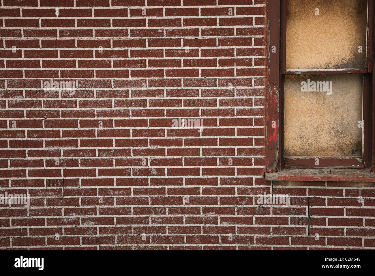 Alberta, Canada; A Red Brick Wall With A Boarded Up Window Stock Photo ...