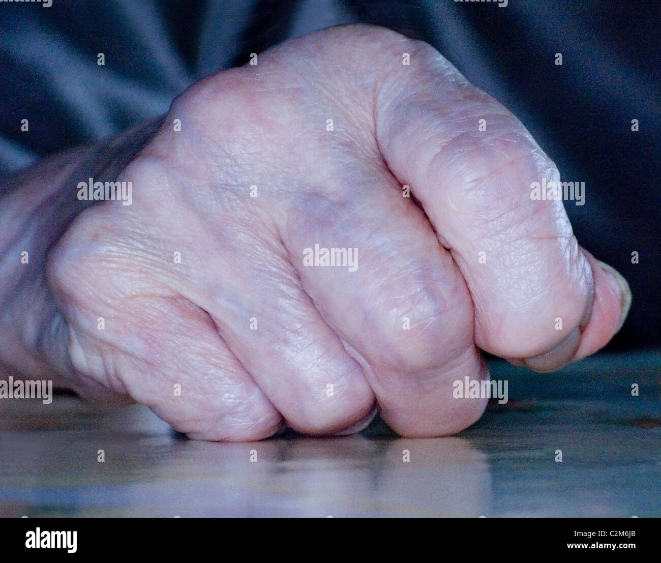 Elderly woman's hand on table Stock Photo - Alamy