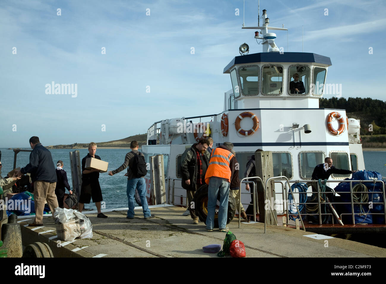 Unloading ferry on the jetty Herm island Channel islands Stock Photo ...
