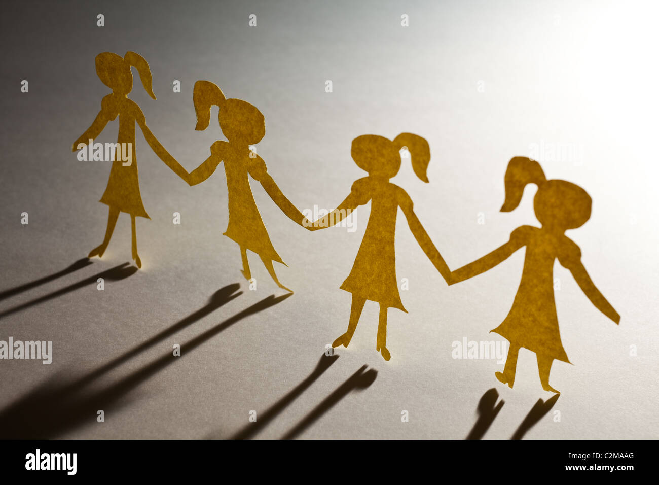 Paper Chain girls, concept of Teamwork Stock Photo - Alamy