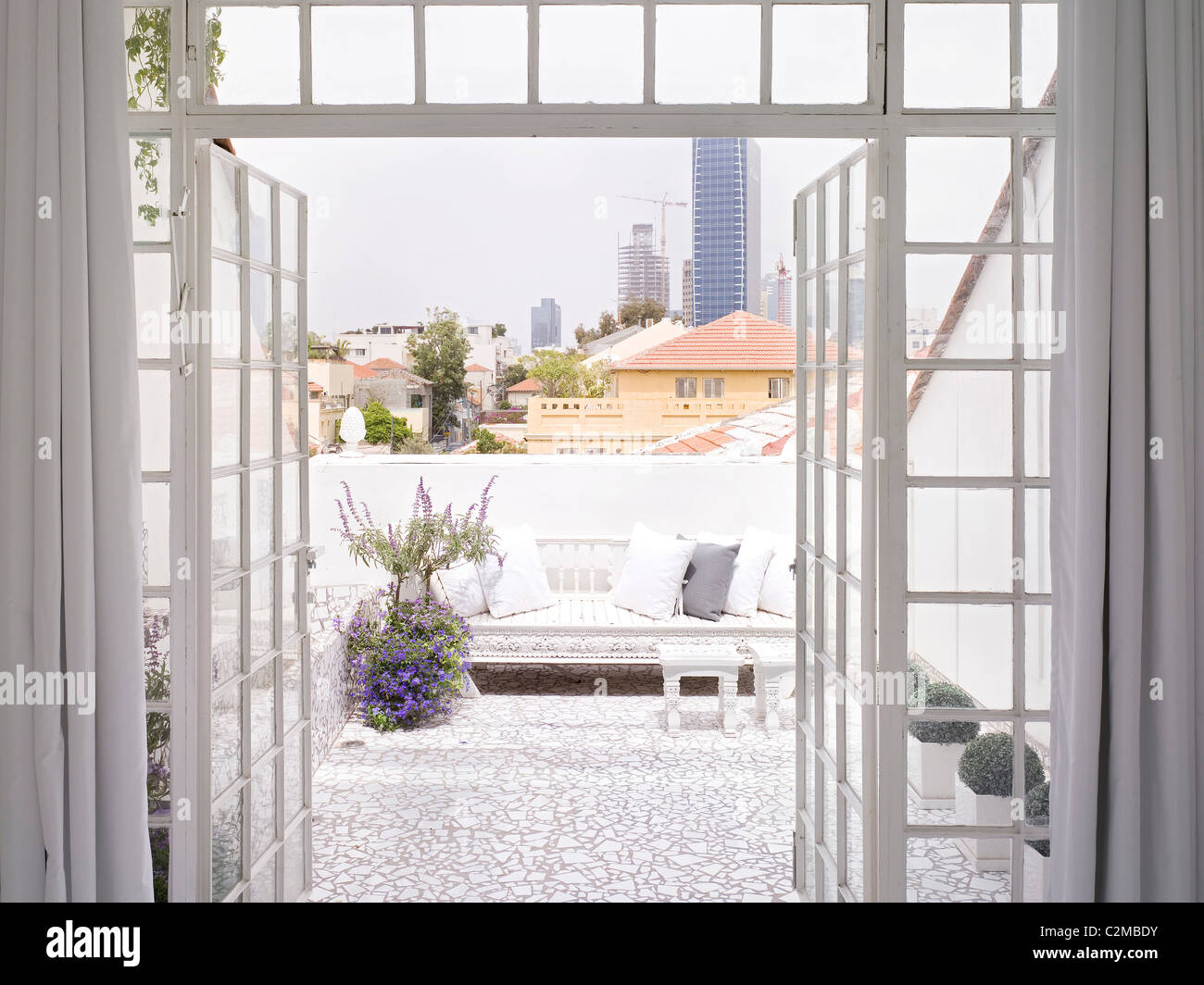 White house. Roof terrace viewed through multi-paned french windows ...
