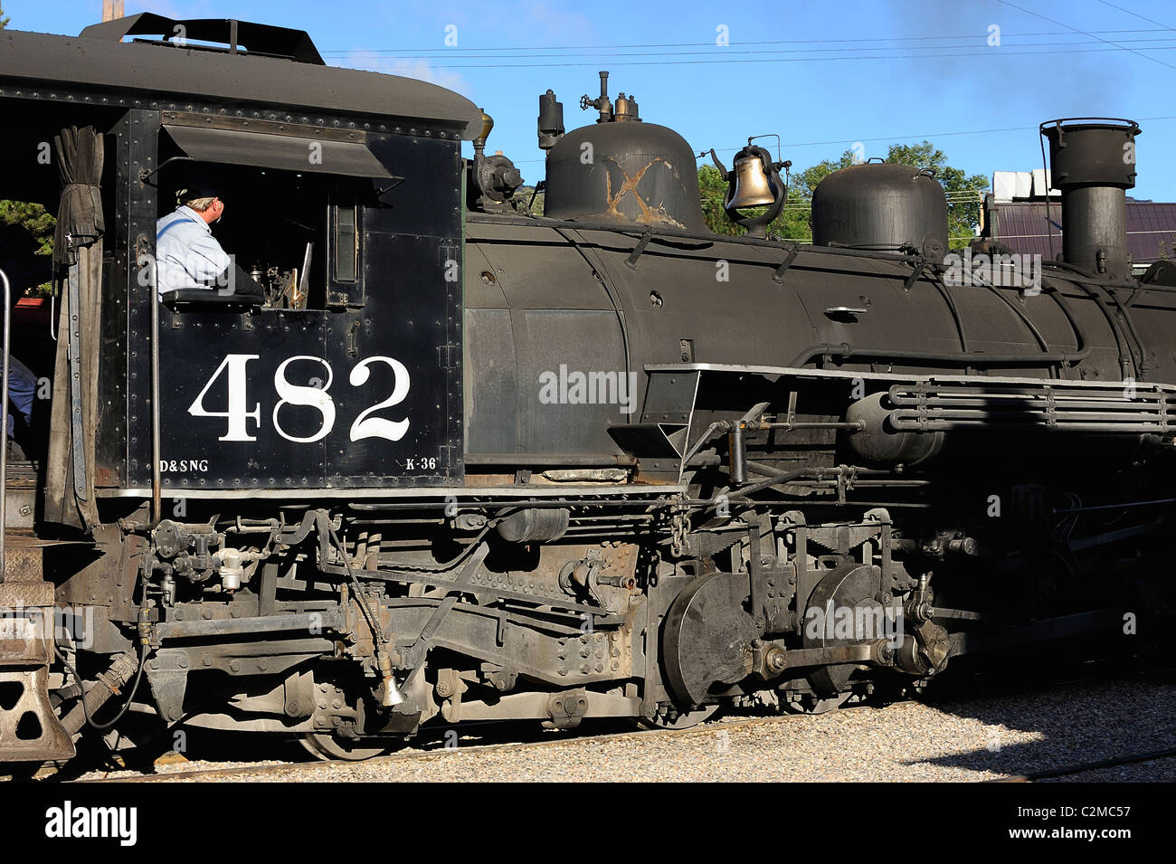 A train driver on board a steam locomotive on the railroad between ...