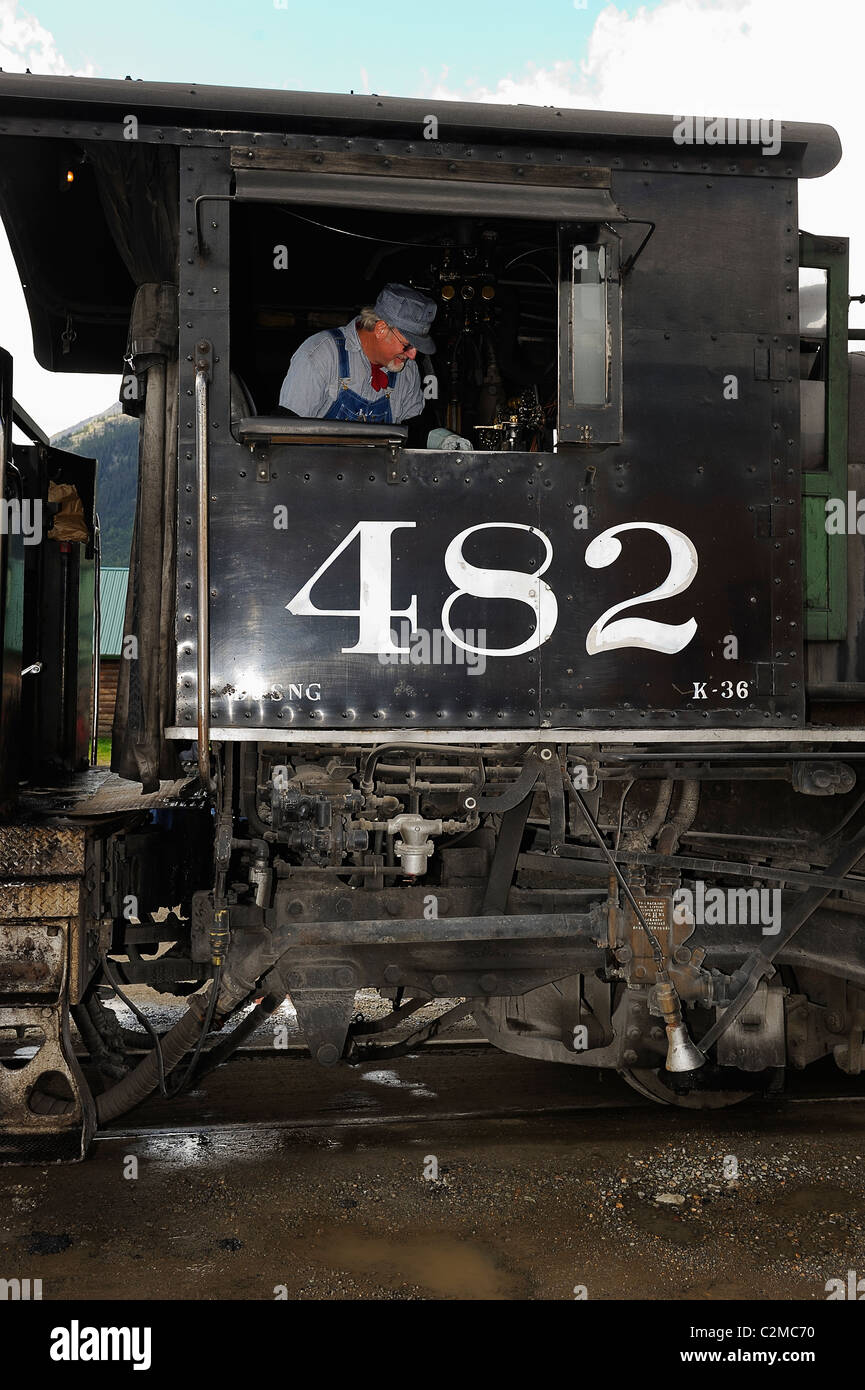 A train driver on board a steam locomotive on the railroad between ...