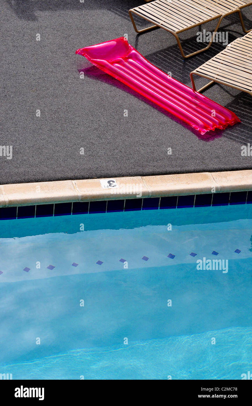 Swimming pool and inflatable raft Stock Photo - Alamy