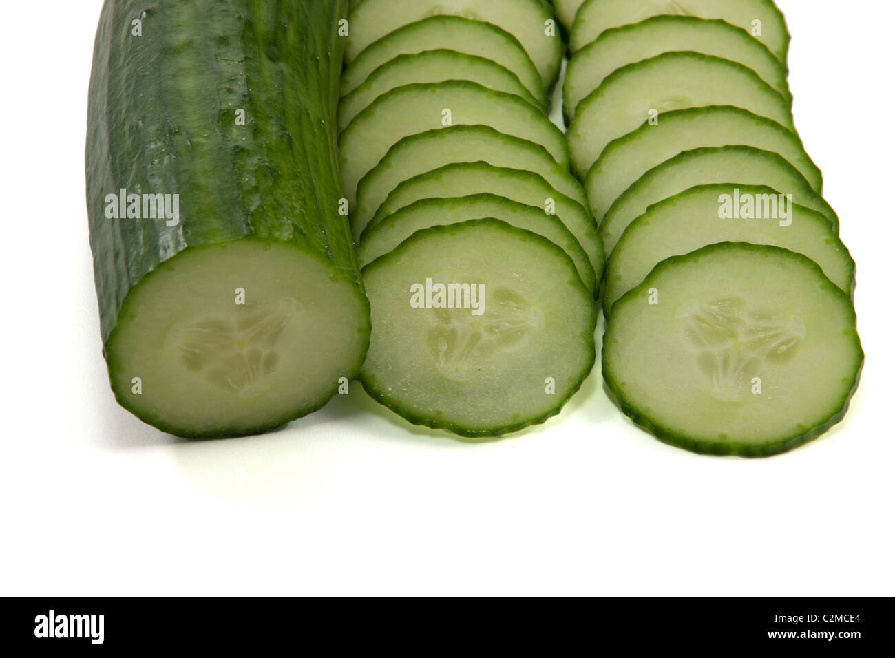 Picture of a half cucumber and some slices Stock Photo - Alamy