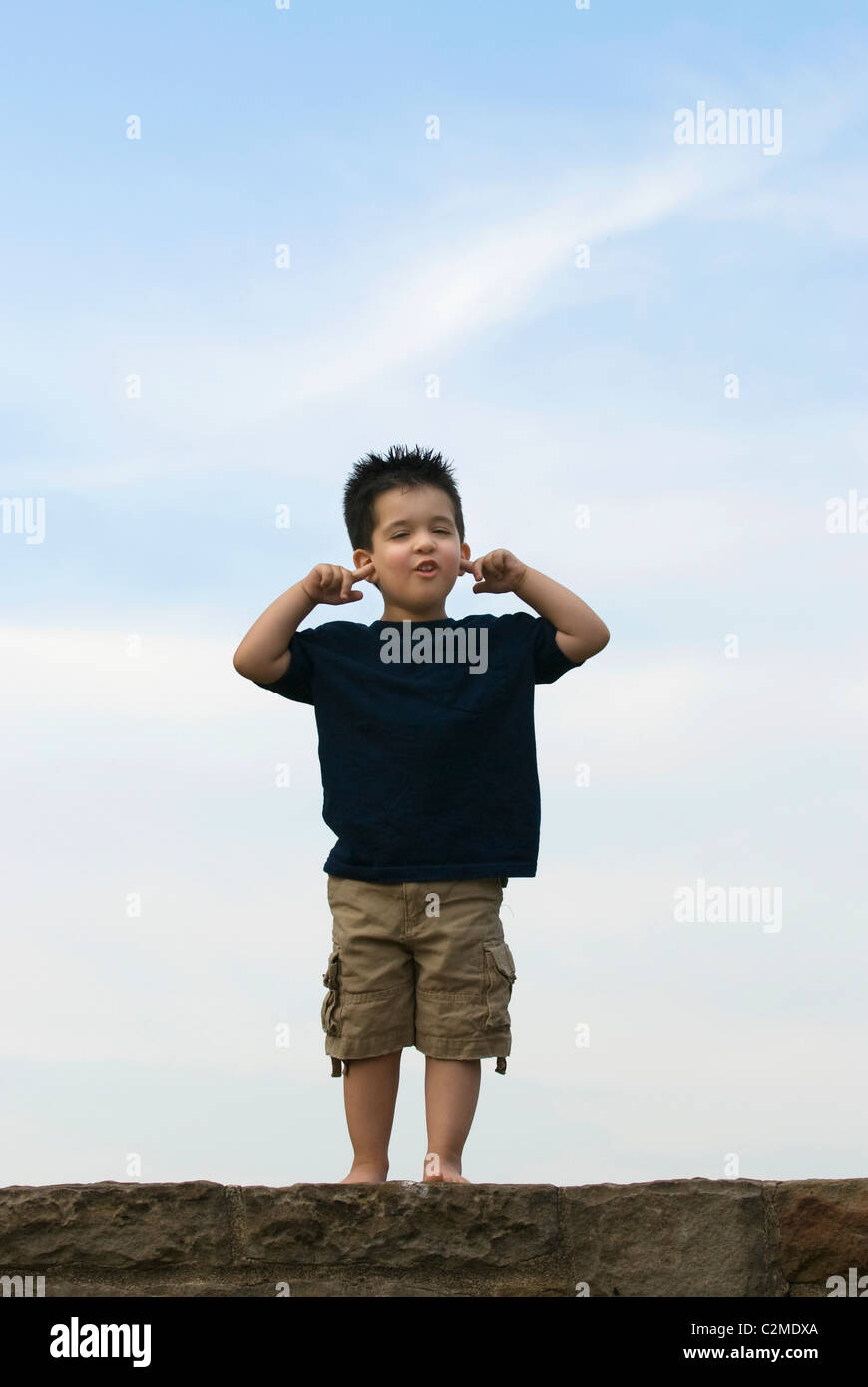 Boy Plugging His Ears Stock Photo - Alamy