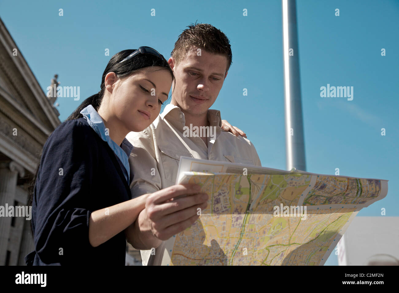 Young Couple Reading Map Stock Photo - Alamy