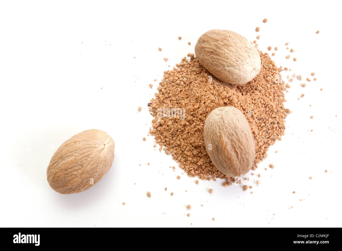 Whole and grated nutmeg isolated on white background Stock Photo - Alamy