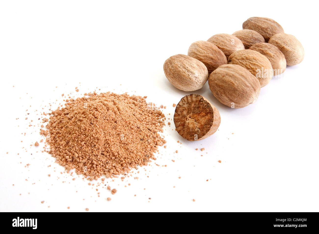 Whole and grated nutmeg isolated on white background Stock Photo - Alamy