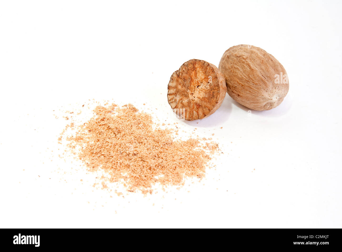 Whole and grated nutmeg isolated on white background Stock Photo - Alamy