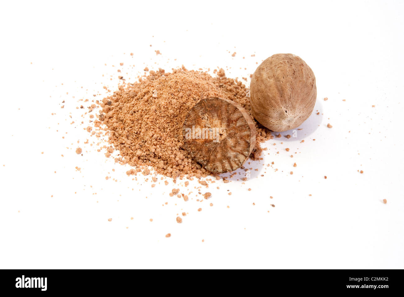 Whole and grated nutmeg isolated on white background Stock Photo - Alamy