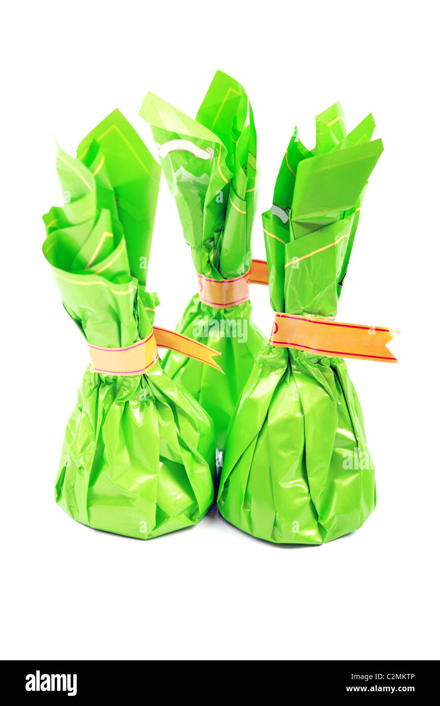 Studio shot of chocolate sweets in green package isolated on white ...