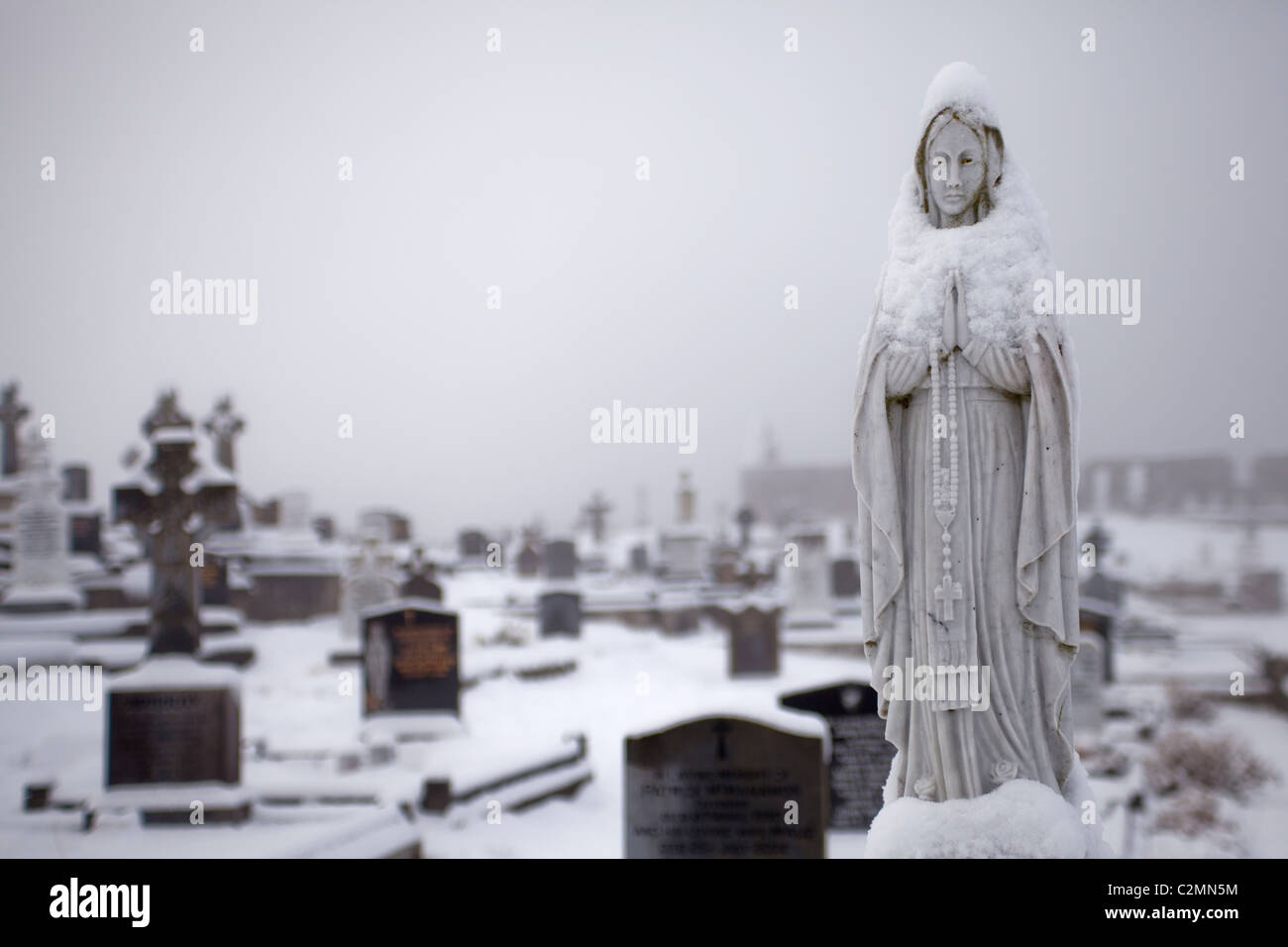 Statue in Burrishoole Abbey's graveyard Ireland in the snow Stock Photo ...