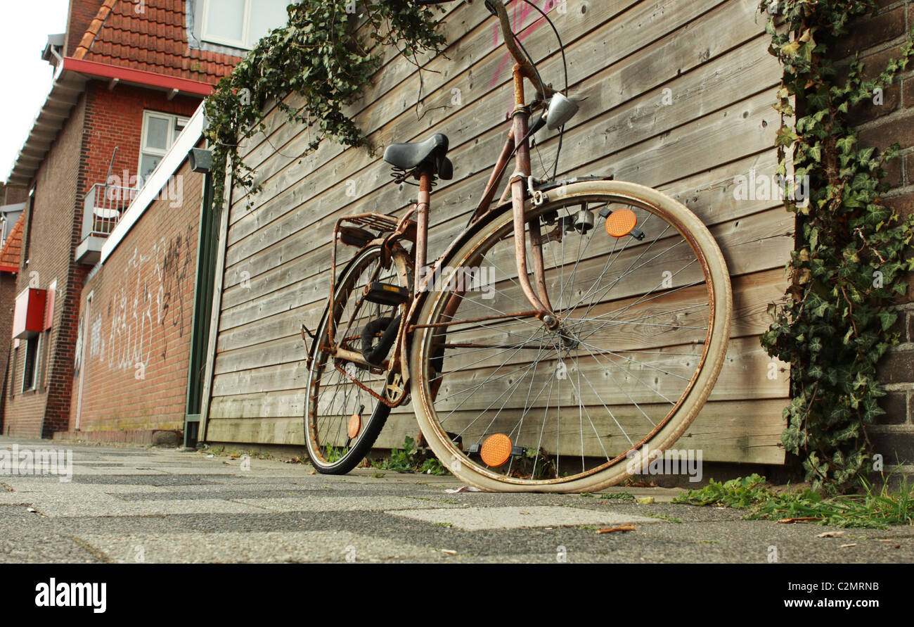 old rusty bike standing on the street Stock Photo - Alamy