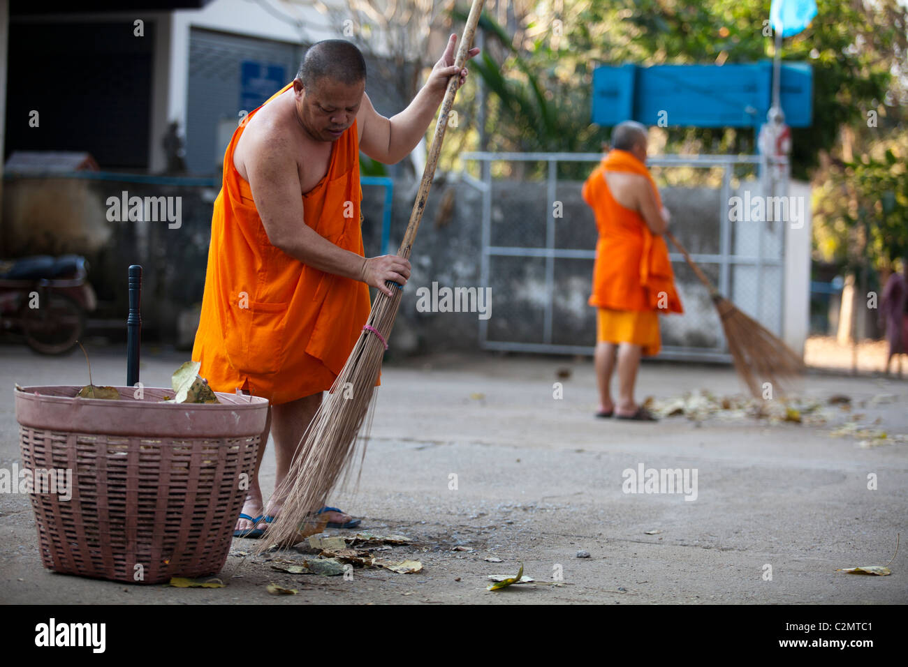 Monk sweep with a broom at the temple, Lampang, Thailand Stock Photo ...