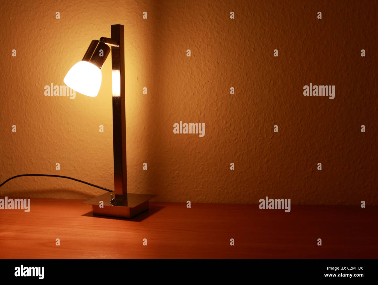 switched on light in the dark on the table Stock Photo - Alamy