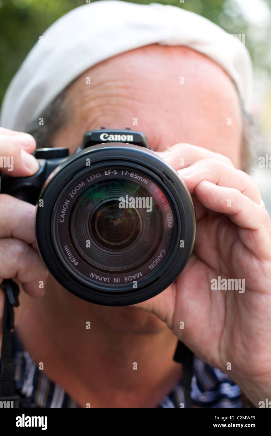 Mature Photographer having fun with his Canon Stock Photo - Alamy