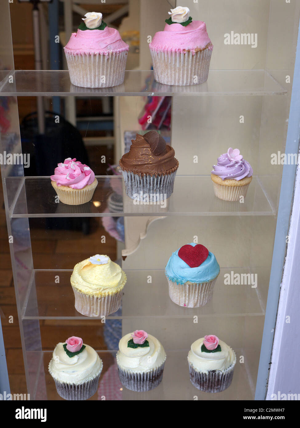 A view of a colourful display of cupcakes in a shop window Stock Photo ...