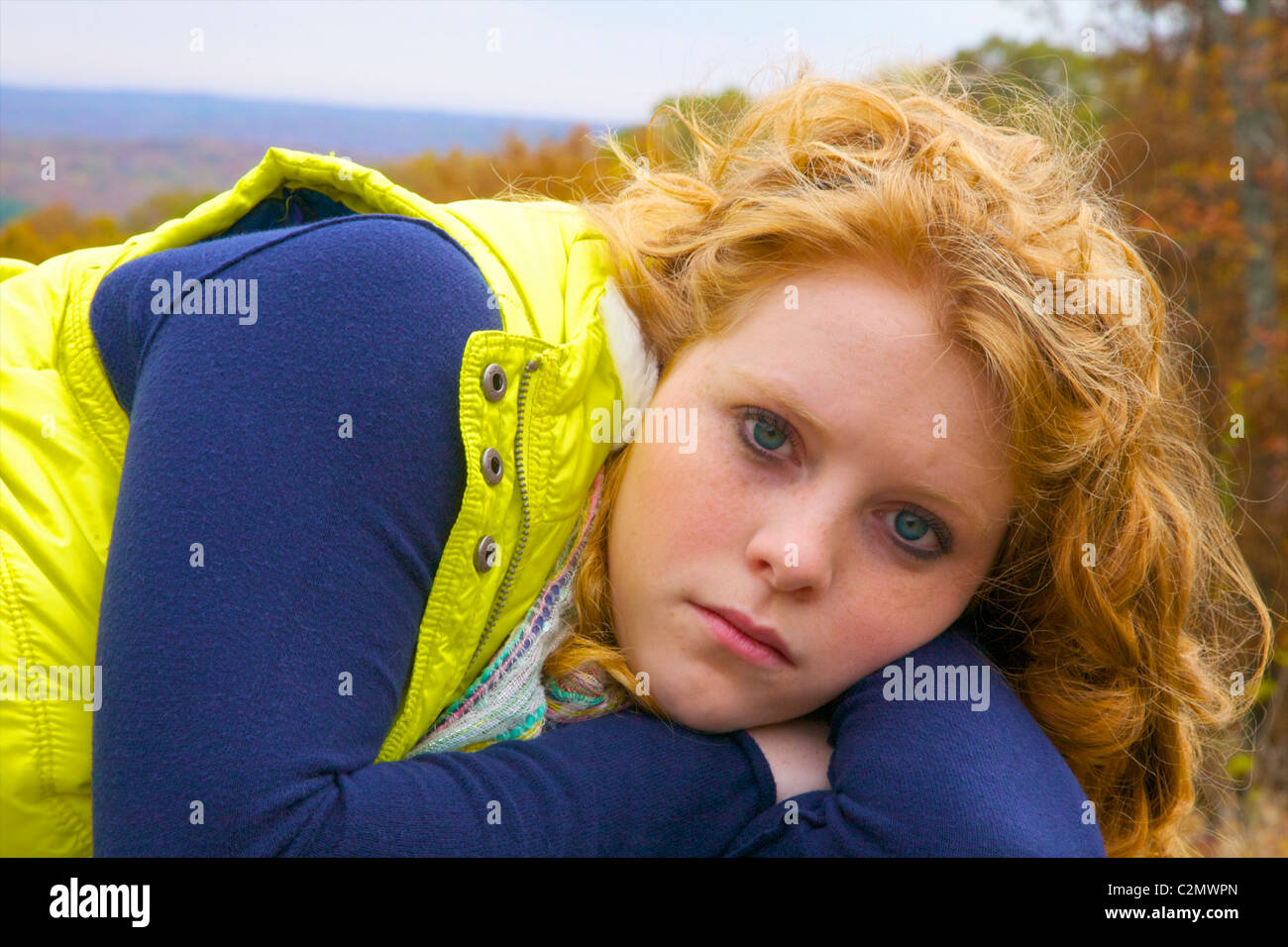 A close-up of a beautiful redheaded girl with a reflective expression ...